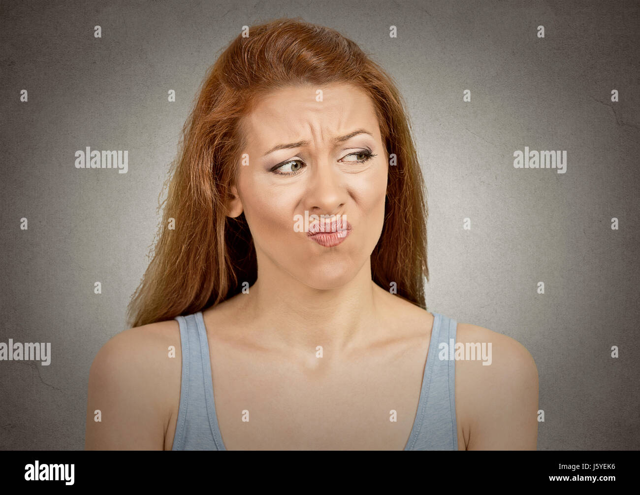 Upset disgusted woman with displeased face expression isolated on grey ...