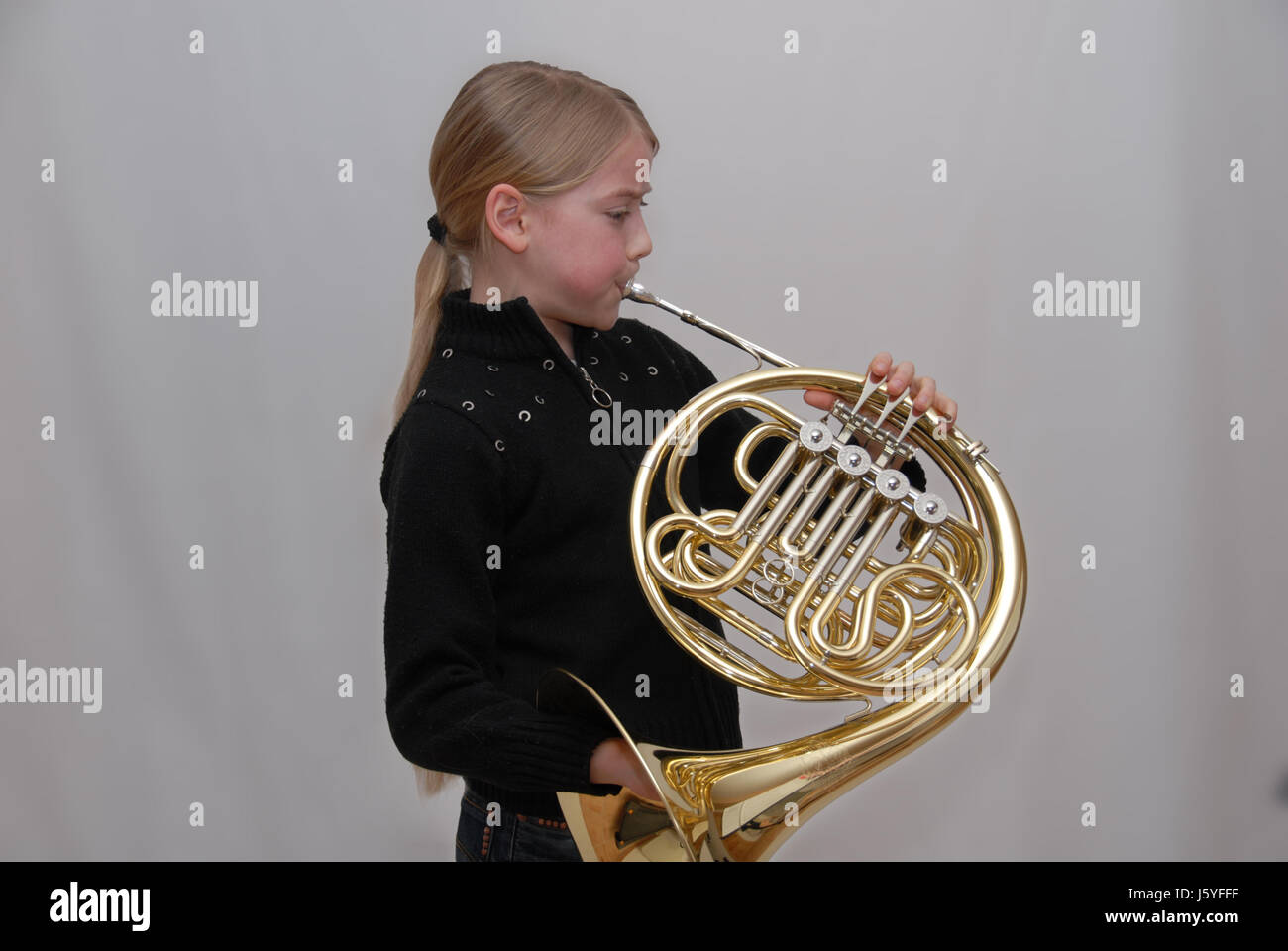 girl playing horn Stock Photo - Alamy