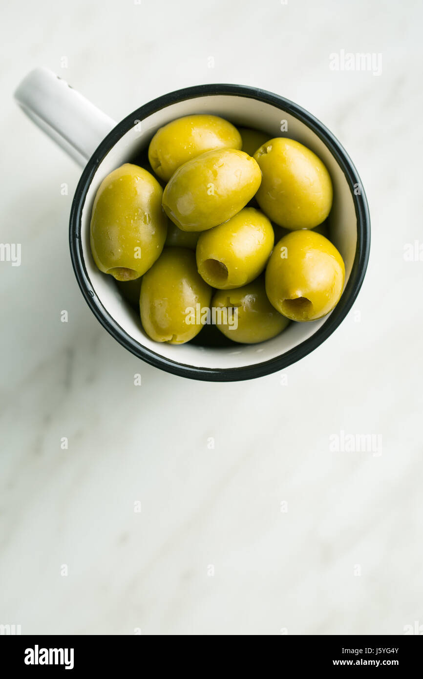 The green olives in cup. Top view Stock Photo - Alamy
