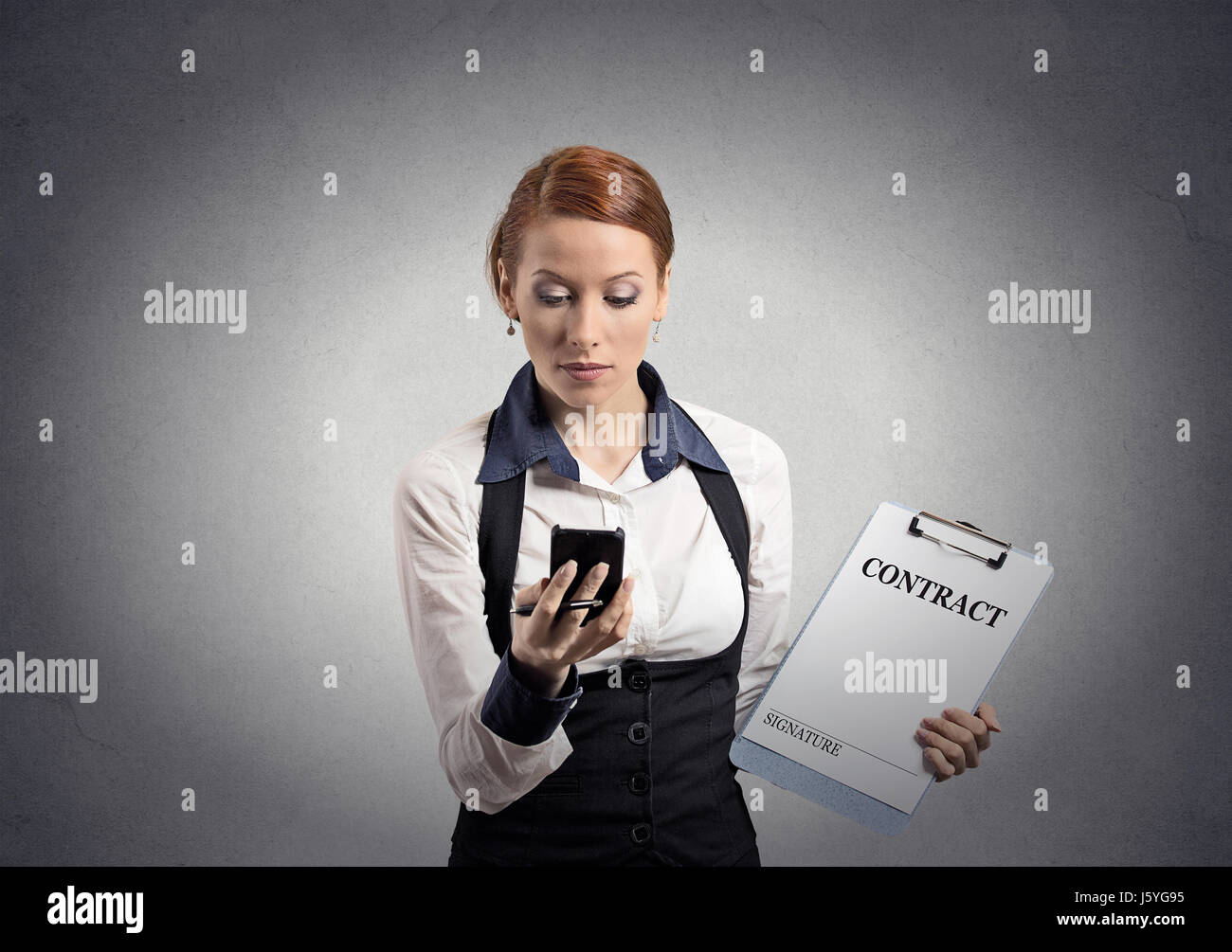 Portrait serious businesswoman signing holding contract document ...