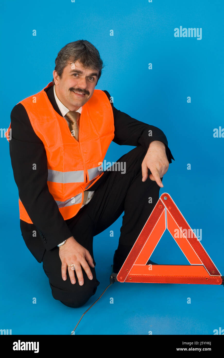 breakdown kneeling warning triangle suit man wait waiting studio ...