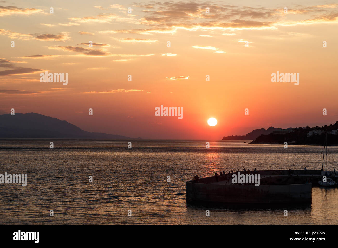 Beautiful sunset with sea and pier in Loutraki, Grecee Stock Photo - Alamy