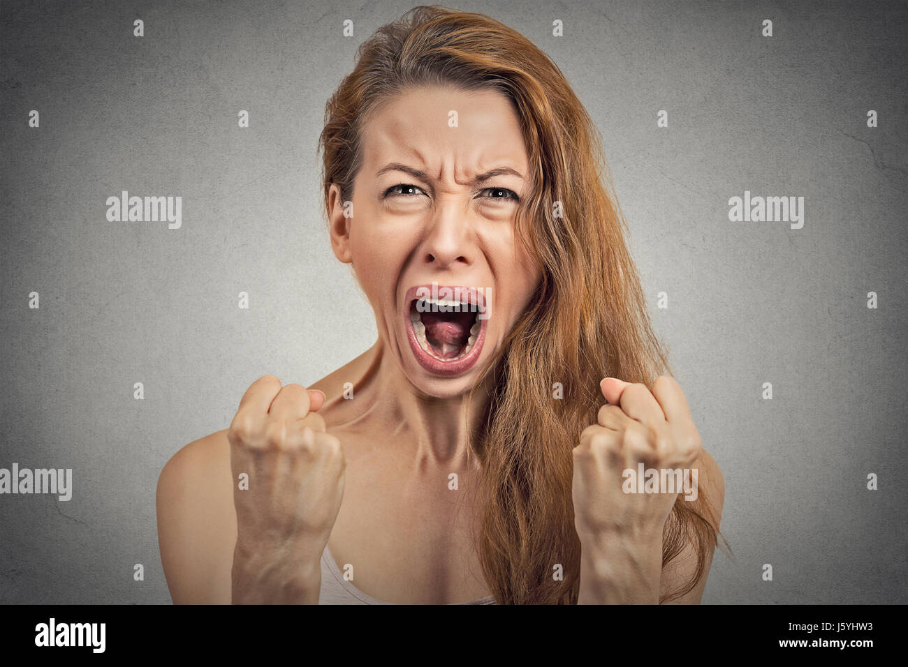 Closeup portrait angry young woman hysterical having nervous atomic ...