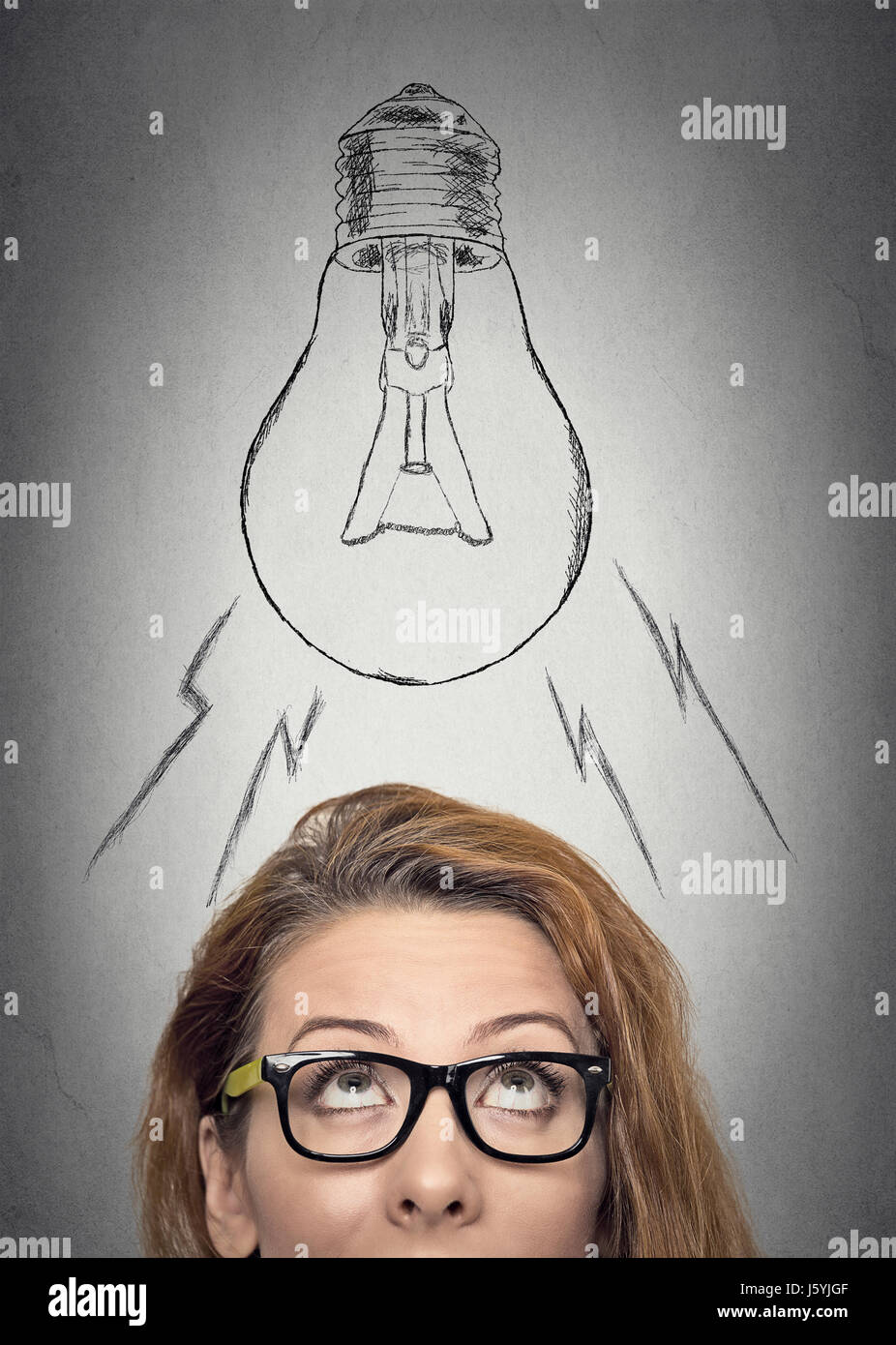 Headshot thinking businesswoman with glasses having an idea looking up ...