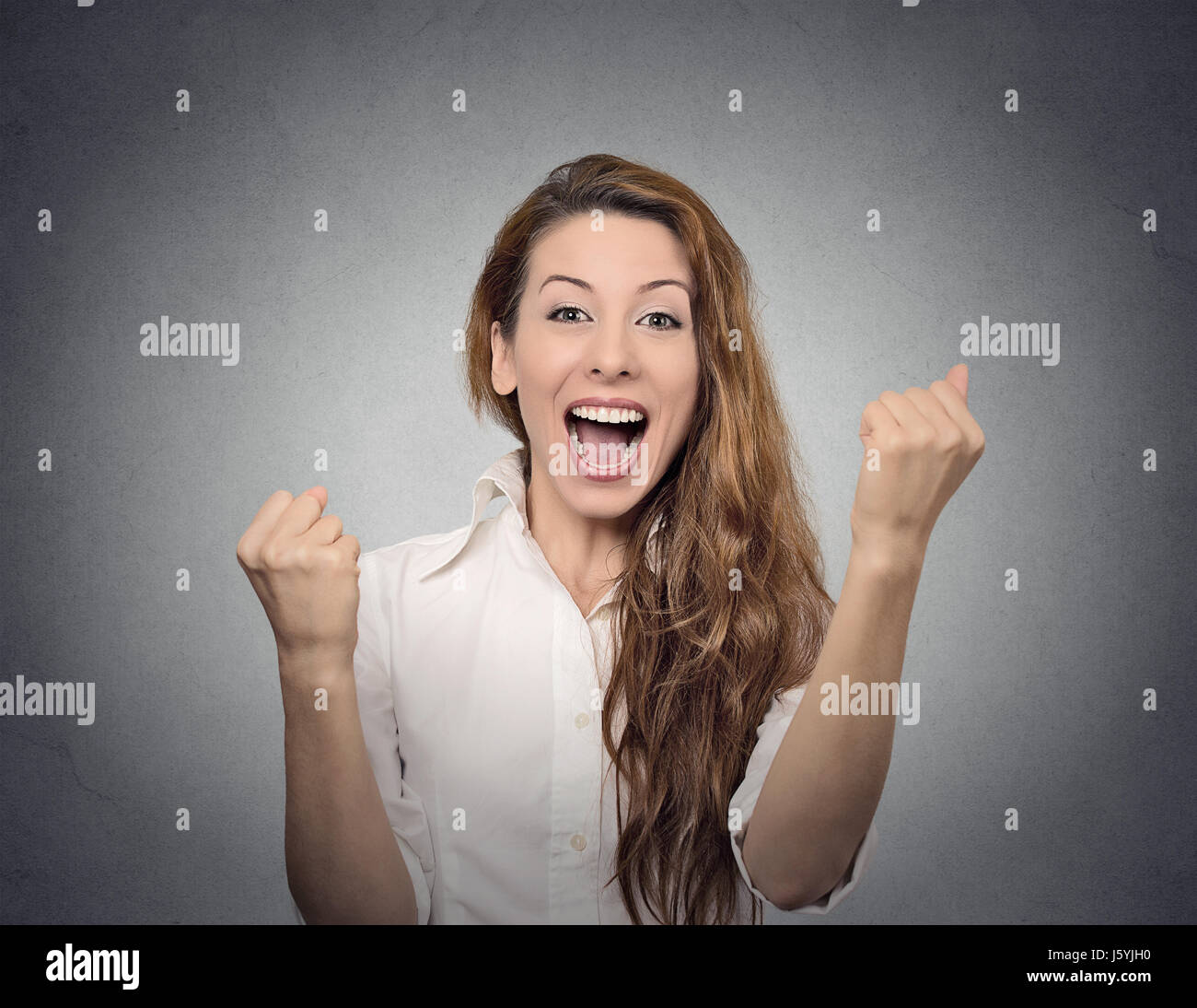 happy woman exults pumping fists ecstatic celebrates success Stock ...
