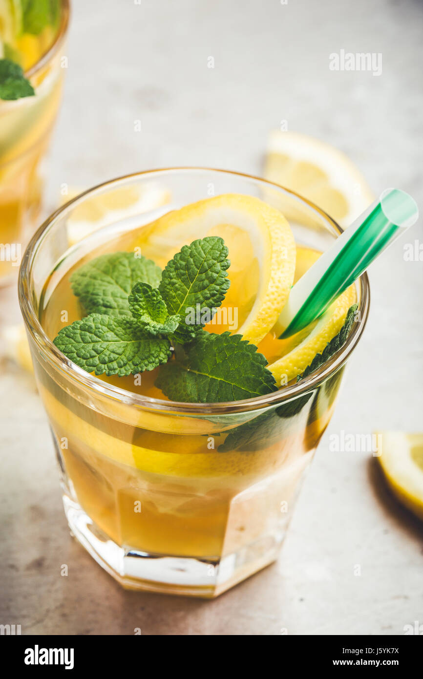 Homemade iced lemon sweet tea with mint on light gray table, delicious ...