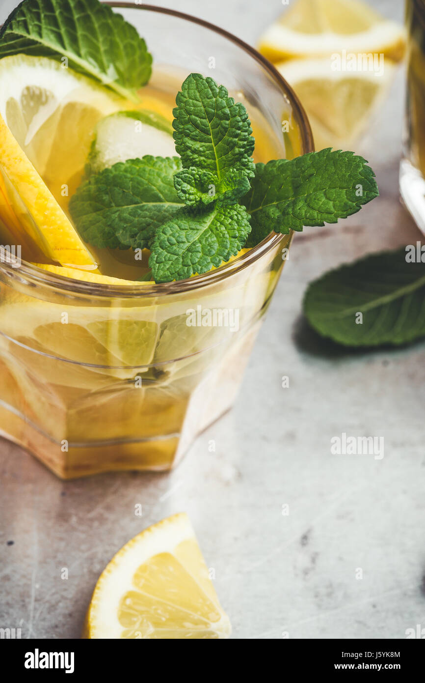 Homemade iced lemon sweet tea with mint on light gray table, delicious ...