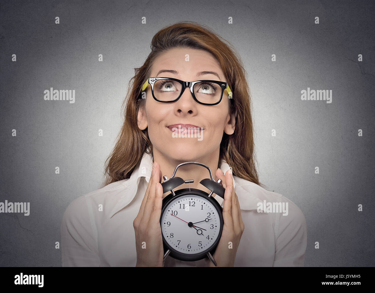 alarm-clock. headshot young excited business woman with alarm clock ...