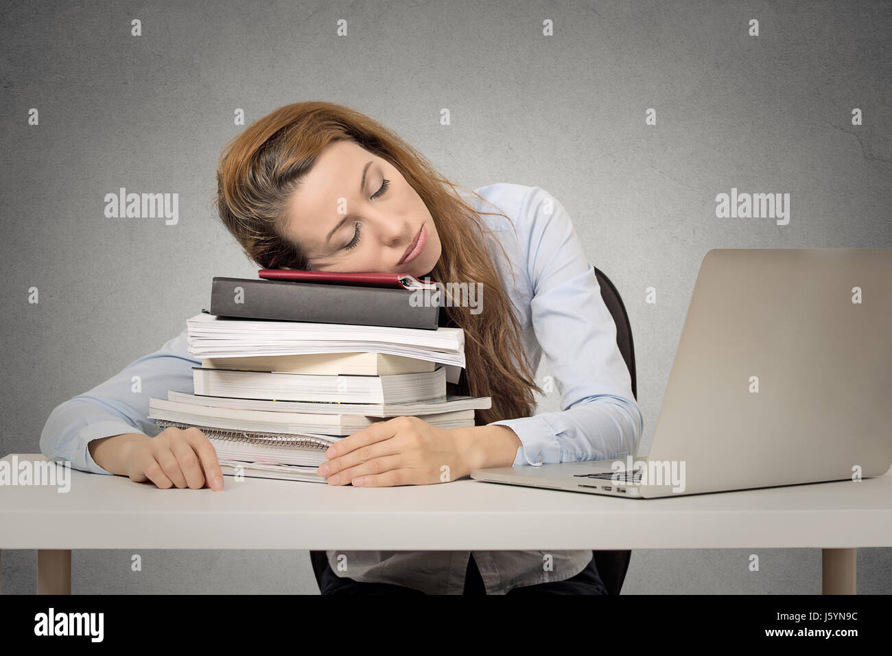 Too much work tired woman sleeping on books at her desk in front of ...