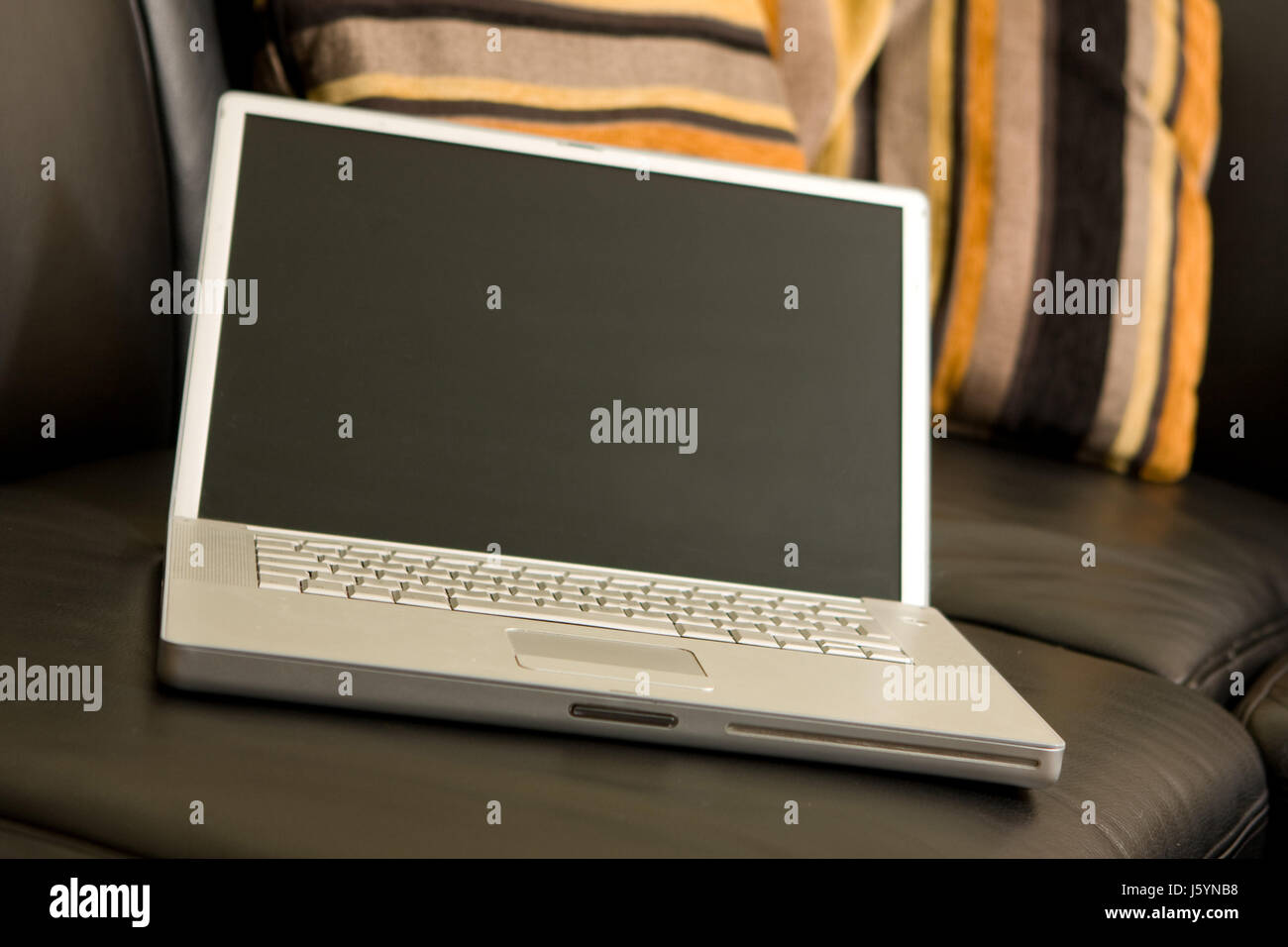 laptop on sofa Stock Photo - Alamy