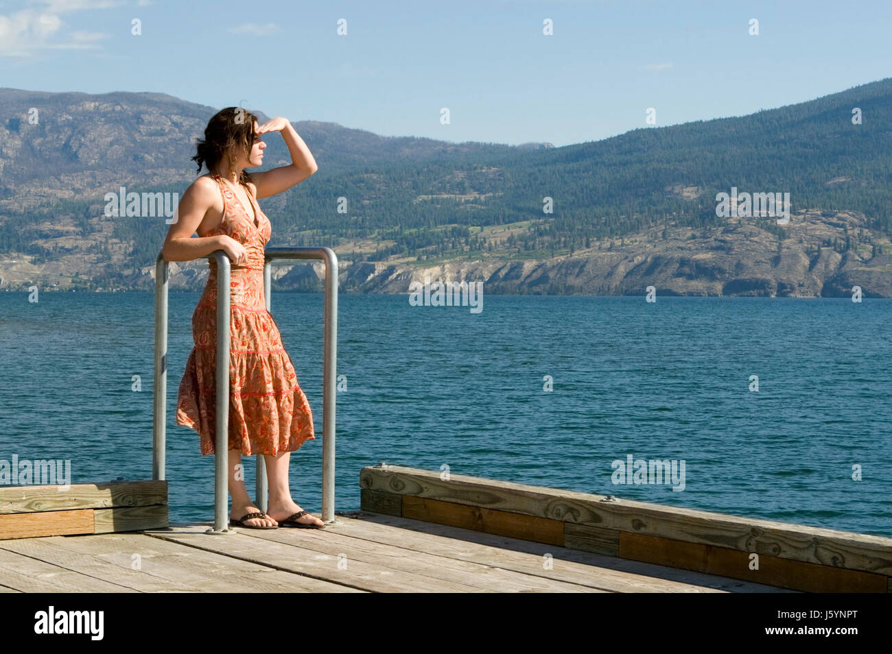 woman standing pier fresh water lake inland water water young younger ...