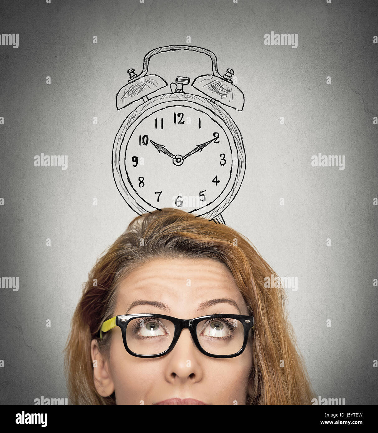 closeup headshot young business woman with alarm clock drawing sketch ...