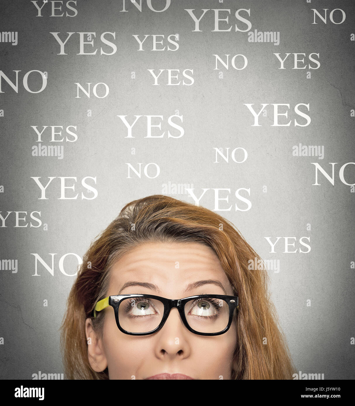 portrait undecided uncertain woman looking up, grey wall background ...