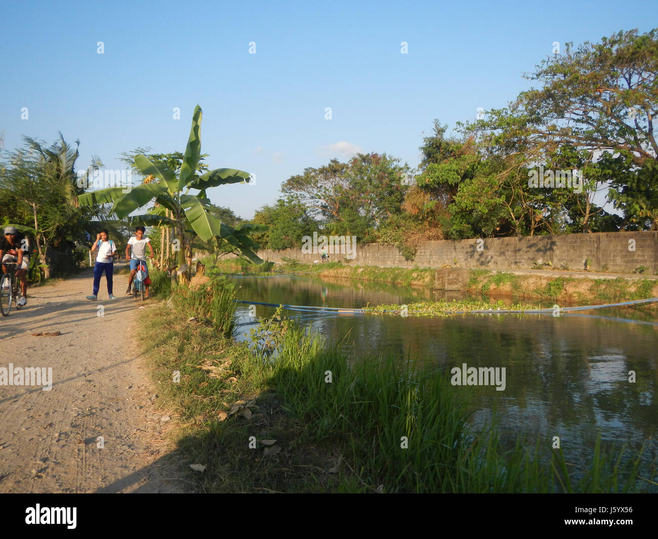 This image shows a sunset over the irrigation bridge at Pulilan ...