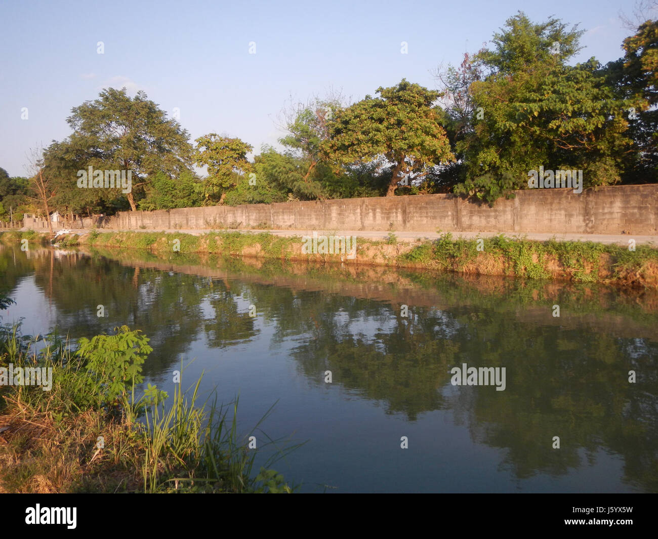 A scenic view of the sunset over the irrigation bridge near Pulilan ...