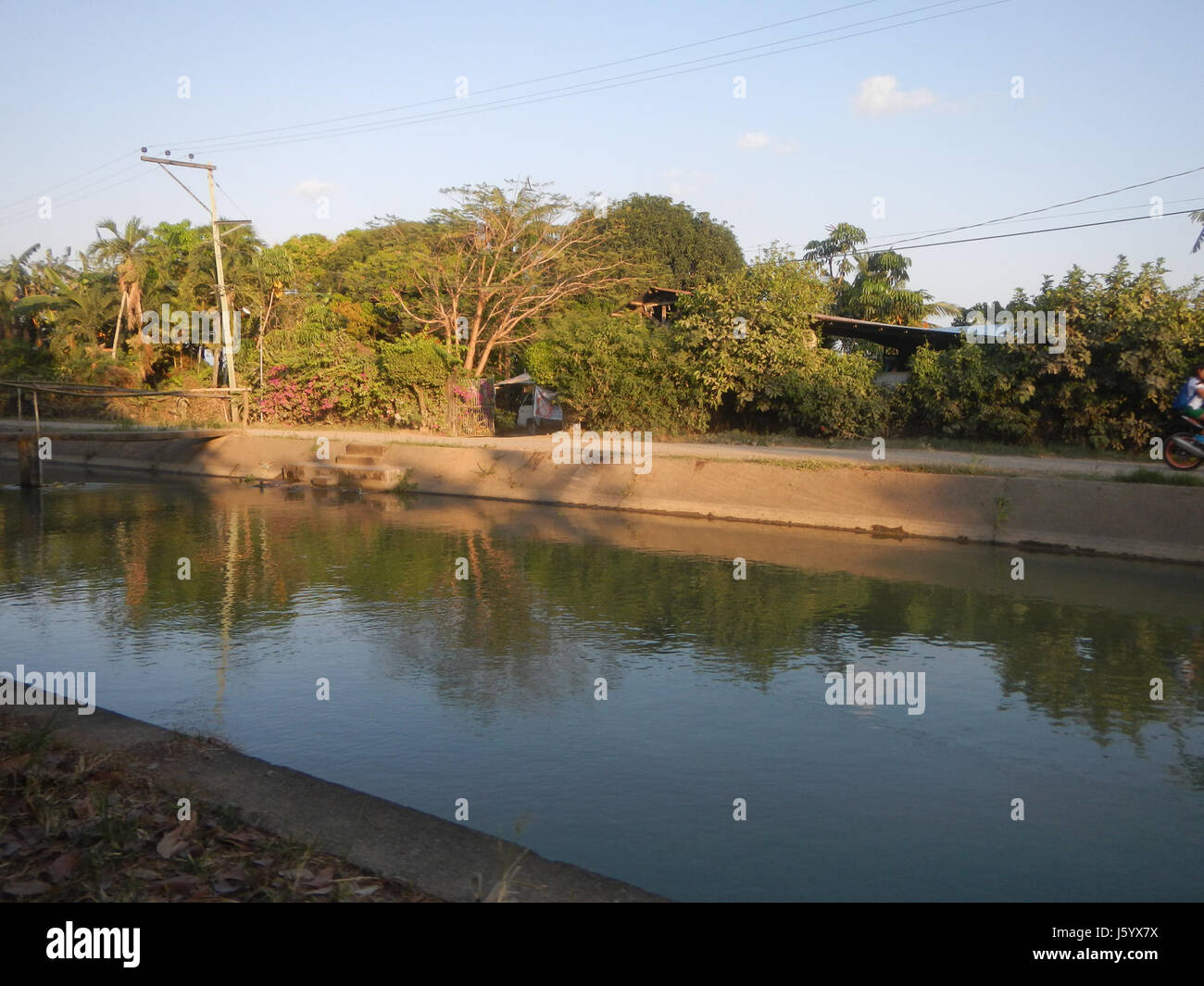 The image shows the sunset view over the irrigation bridge in Pulilan ...