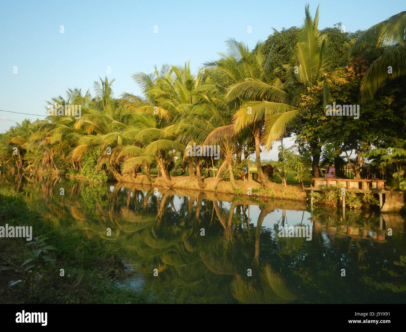This image captures a sunset scene in Bulacan, Philippines, showcasing ...