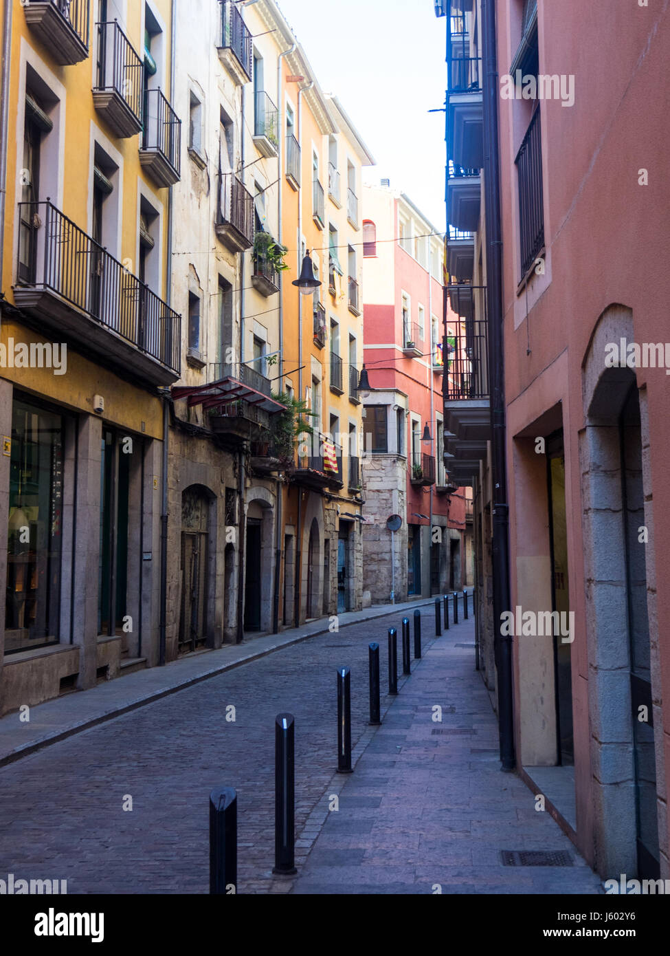 Carrer dels Calderers, a narrow street in the old town of Girona, Spain ...