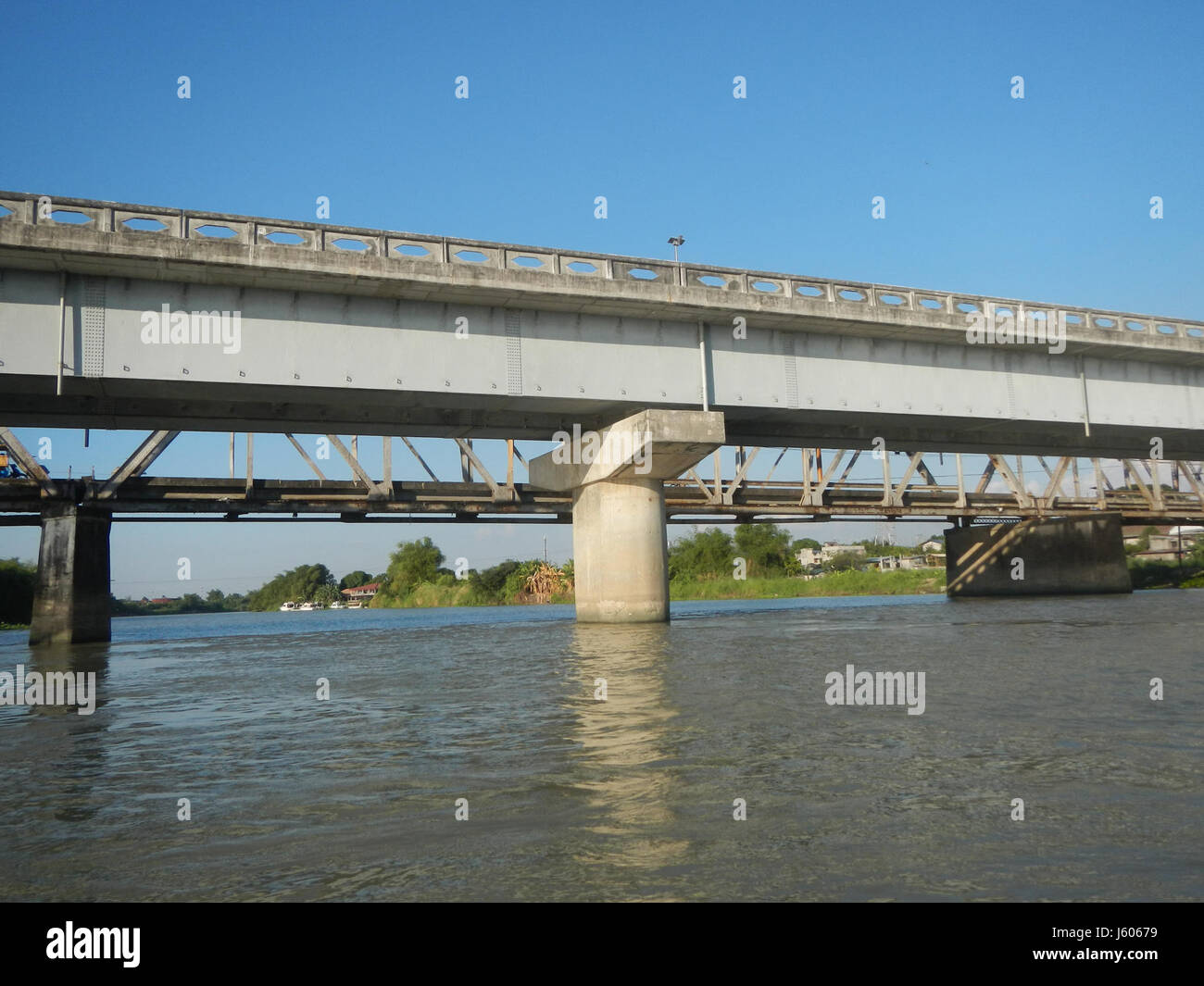 The image shows the Old and New Sulipan Apalit Bridges spanning the ...