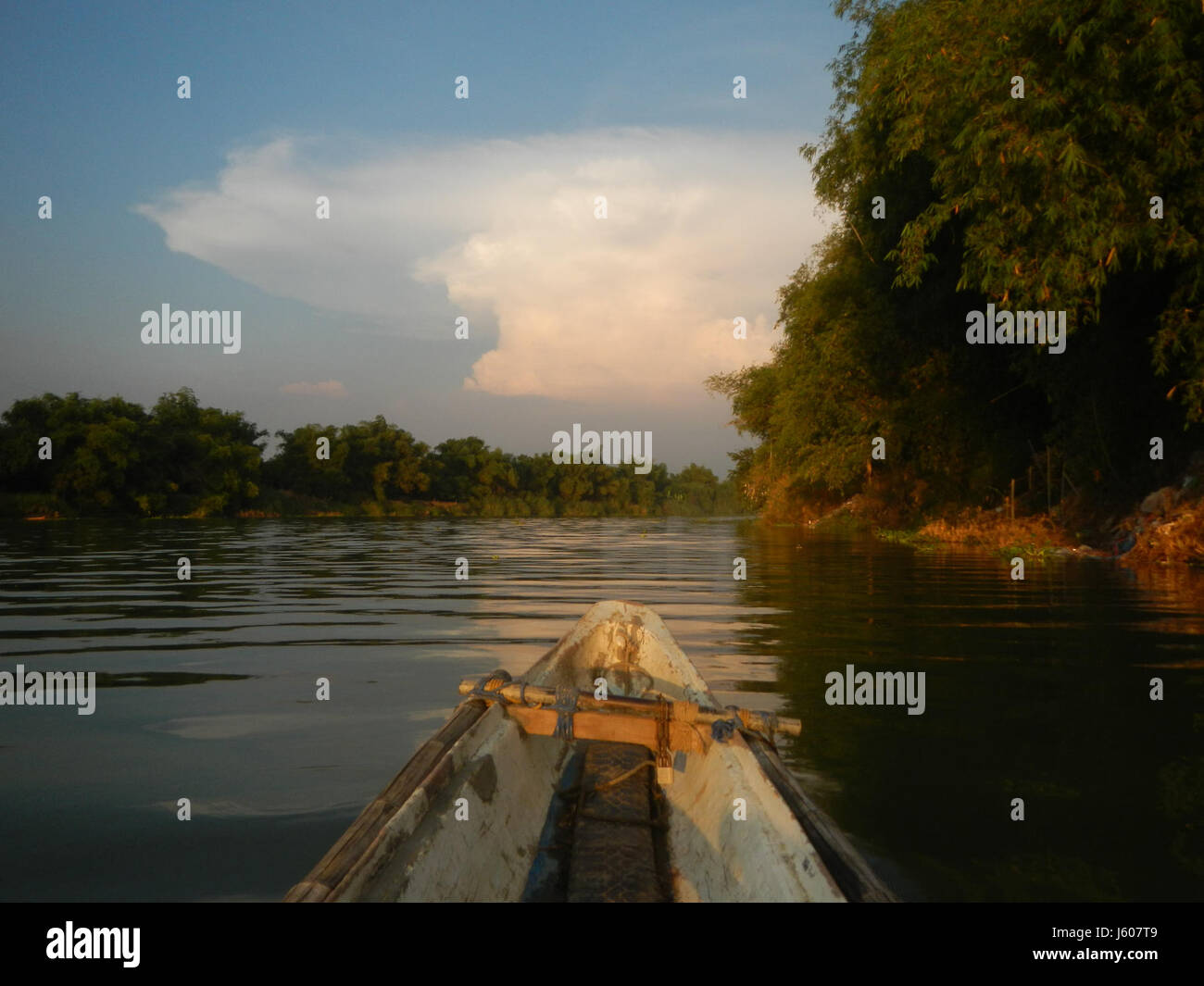 The image captures a beautiful sunset over the Pampanga River districts ...