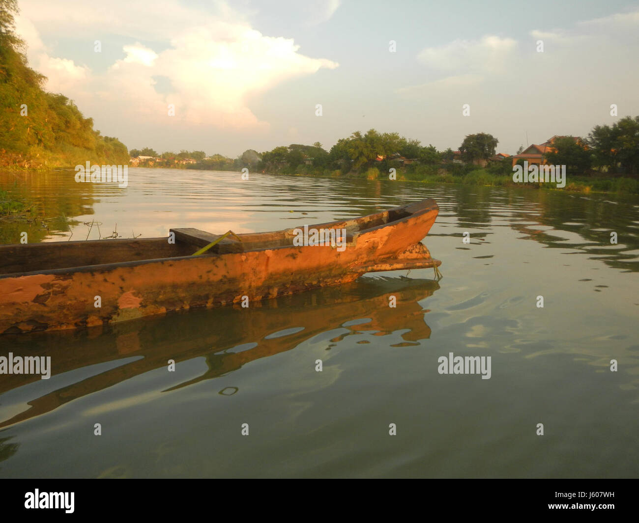 This image depicts the scenic sunset views over the Pambilog River ...