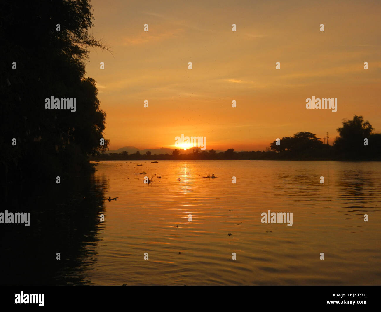The image captures a sunset view of the Pampanga River Districts ...