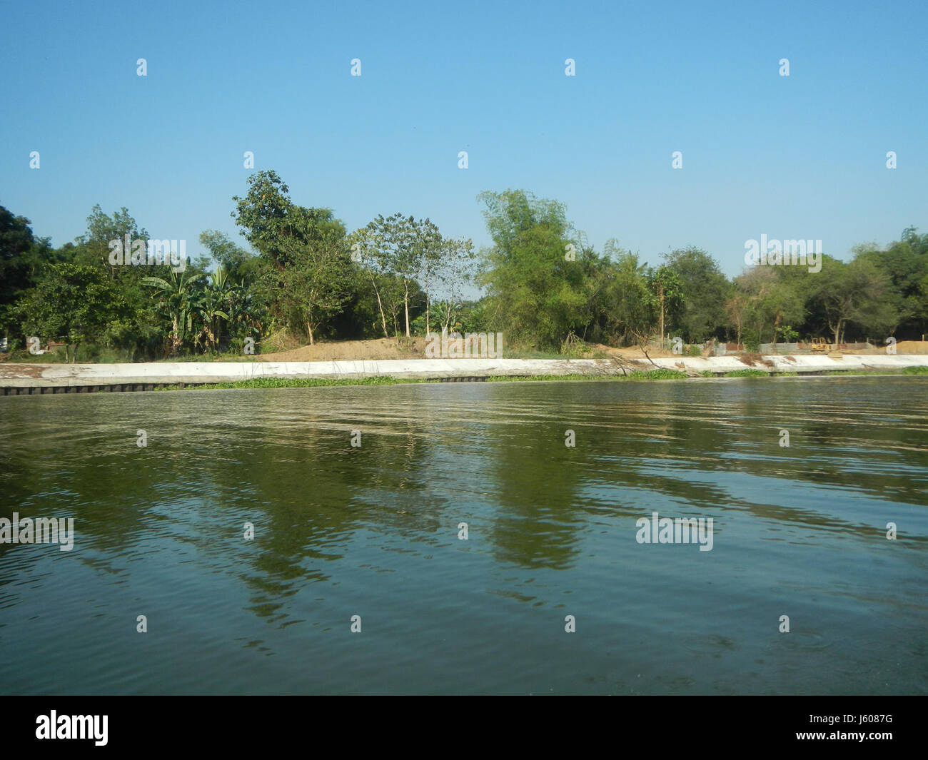 This photograph showcases the riverbanks of Pulilan and Plaridel in ...