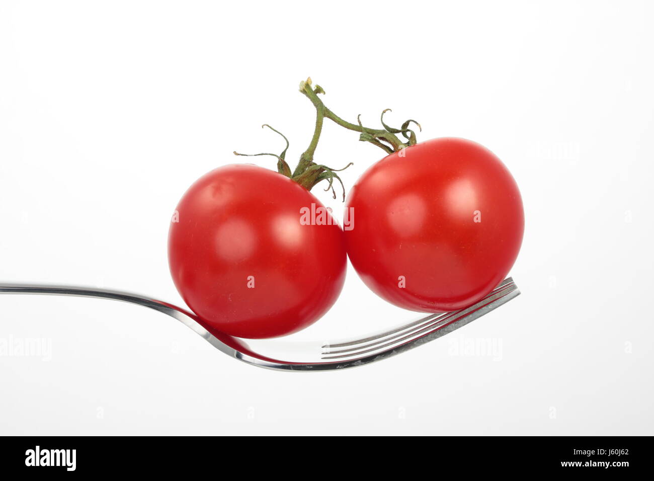 a few tomatoes on a fork Stock Photo - Alamy