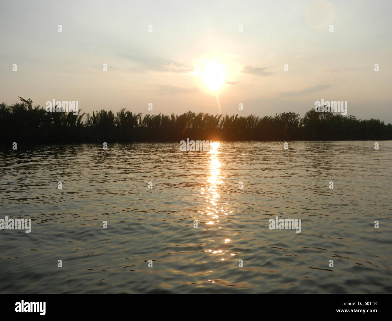 This image captures a sunset over the riverbanks of Panasahan, near ...