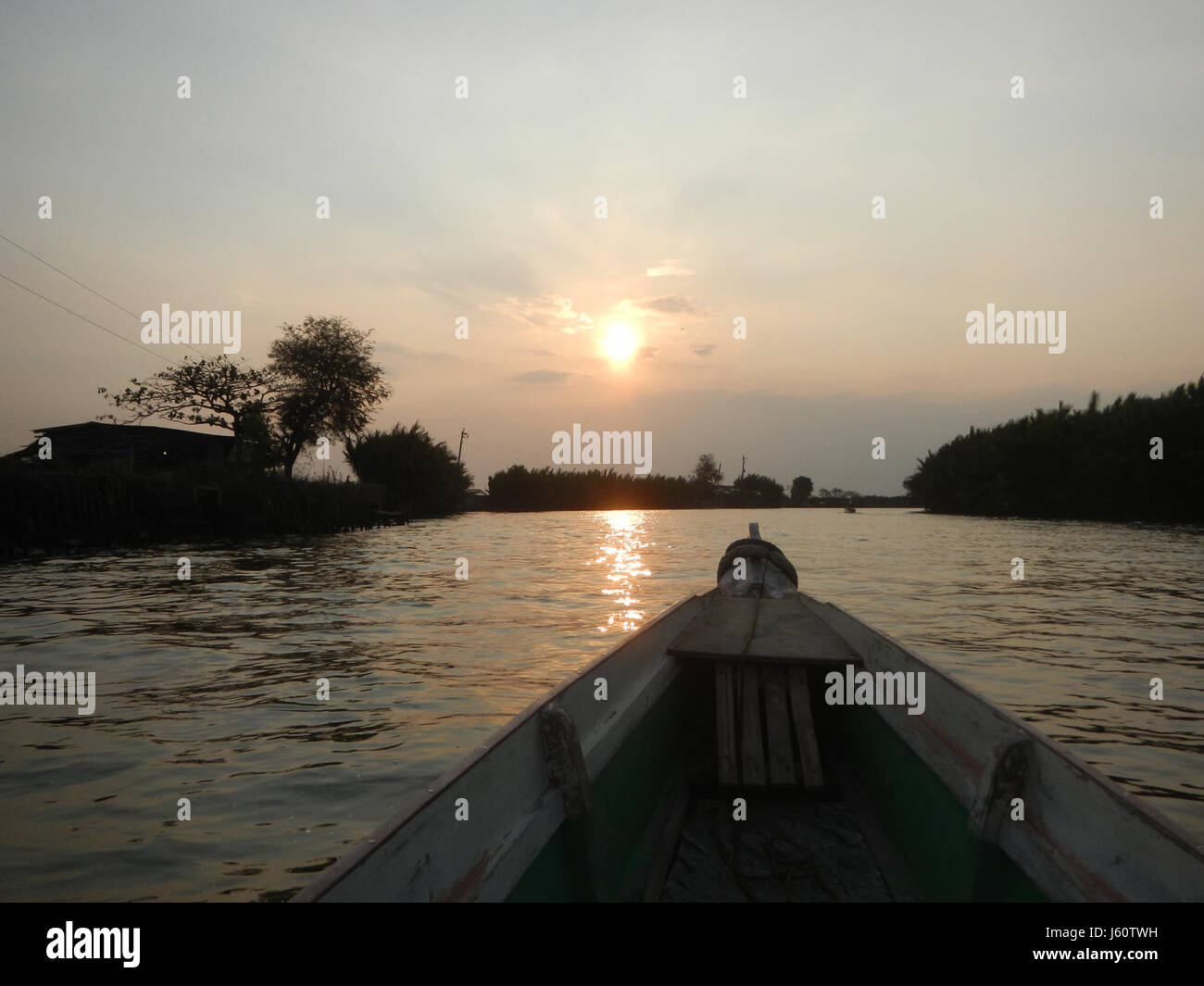 The image captures the sunset over the riverbanks of Panasahan, located ...