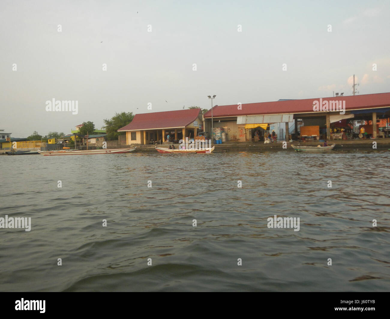 This image captures a beautiful sunset over the river banks of ...