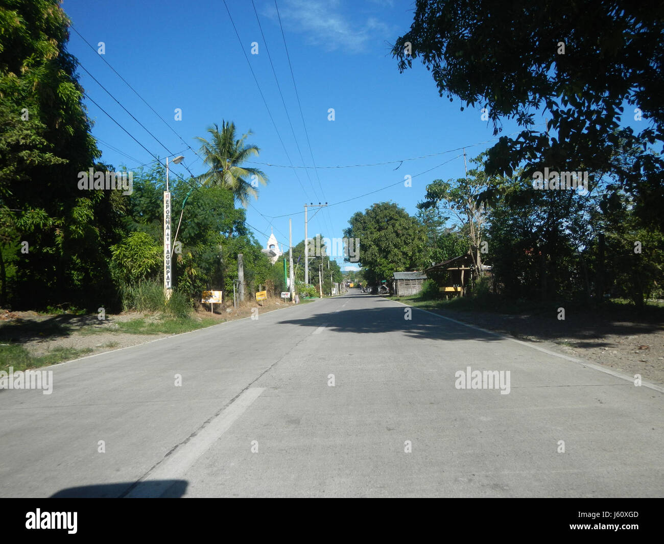 This image features San Miguel Sibul Road in Bulacan, showcasing the ...