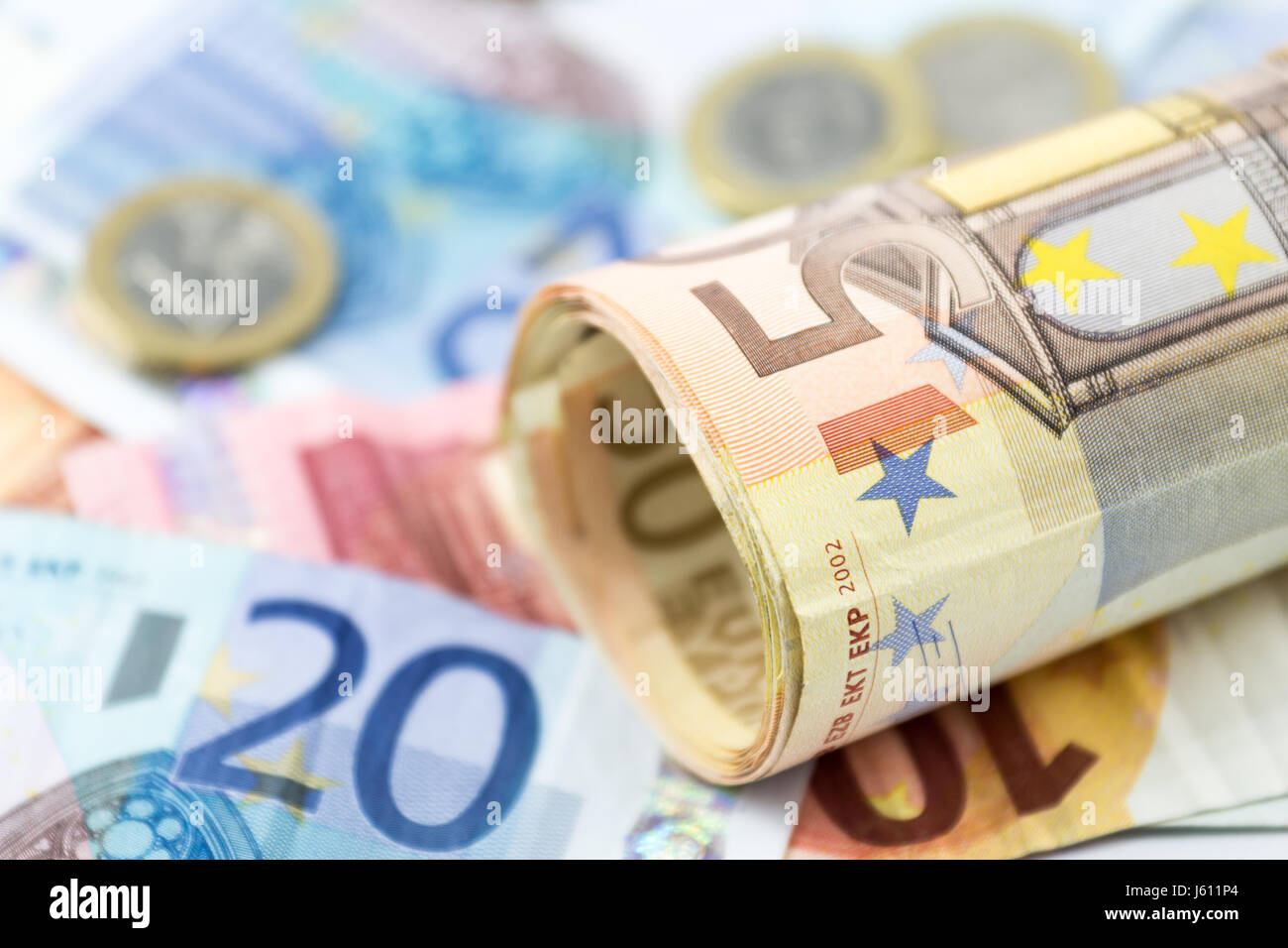 Fifty Euro rolled up on a euro banknotes as a background Stock Photo ...