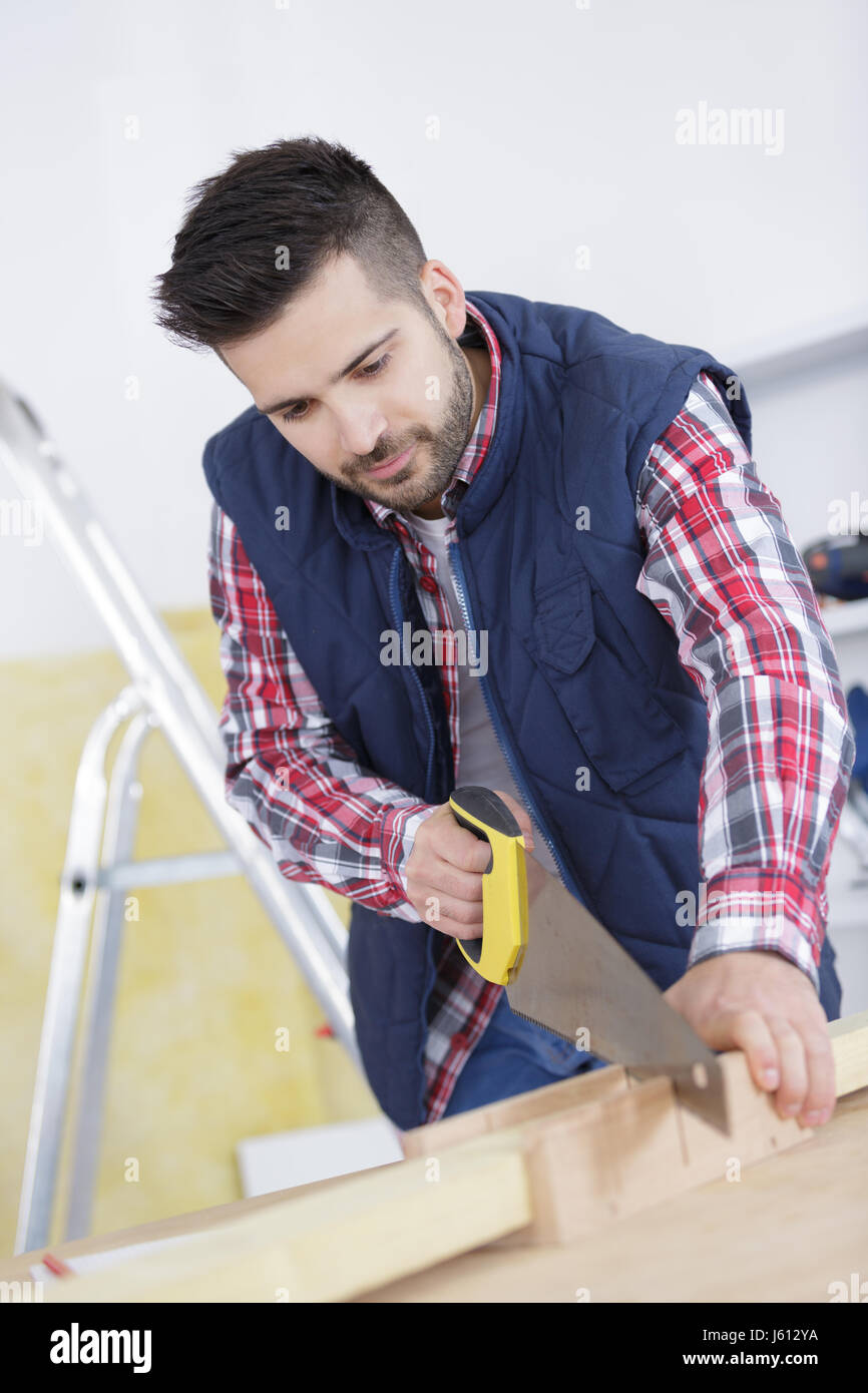 Man sawing wood Stock Photo - Alamy