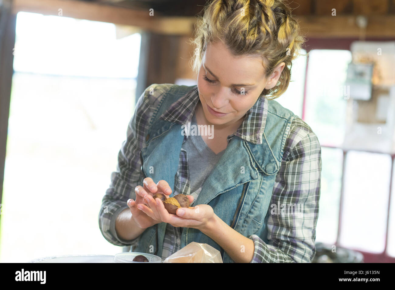 Woman carefully holding object Stock Photo - Alamy