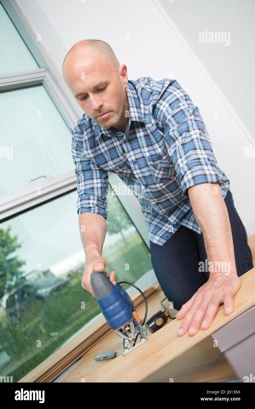 Man using electric jigsaw Stock Photo - Alamy