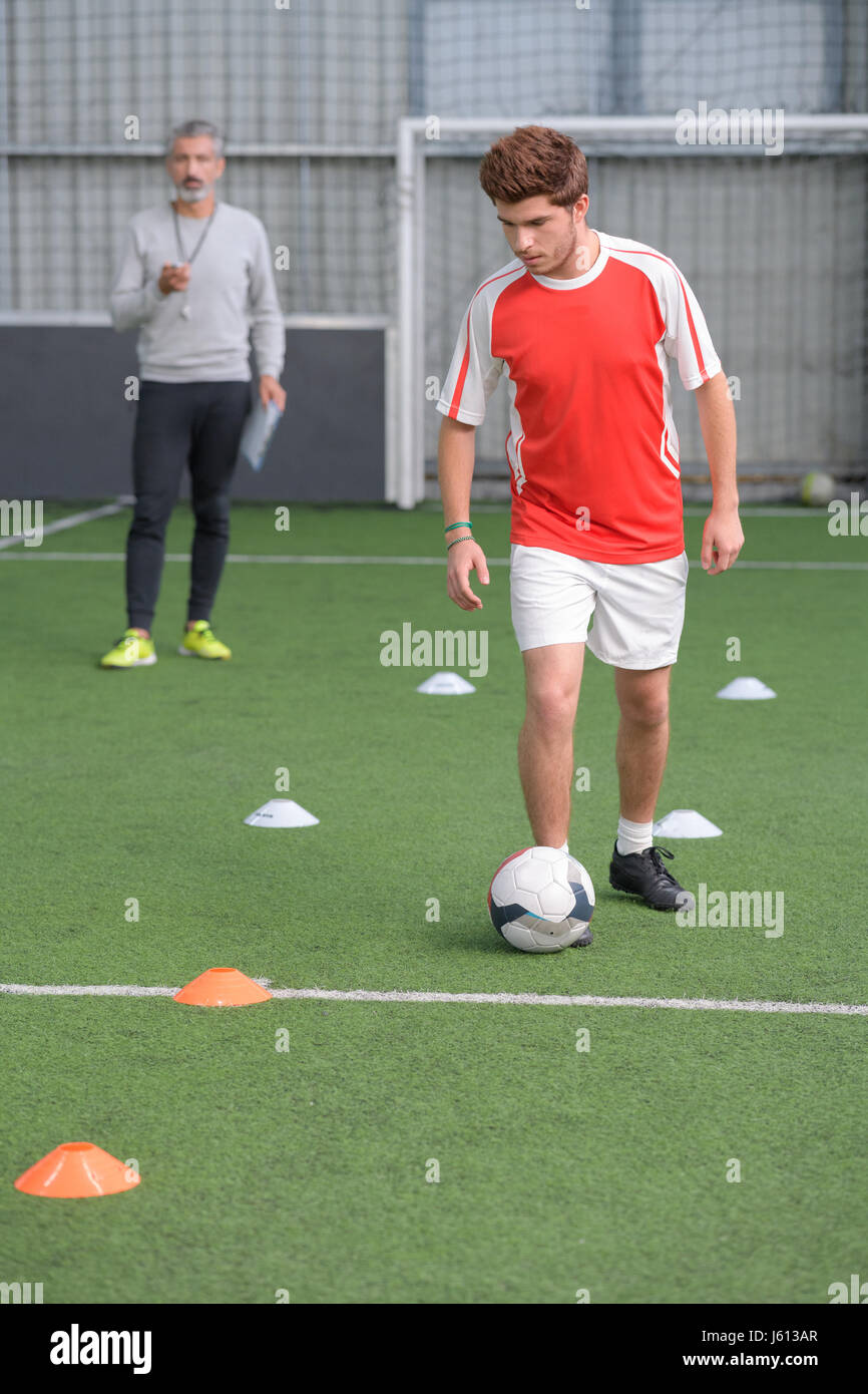 Young man football training Stock Photo - Alamy