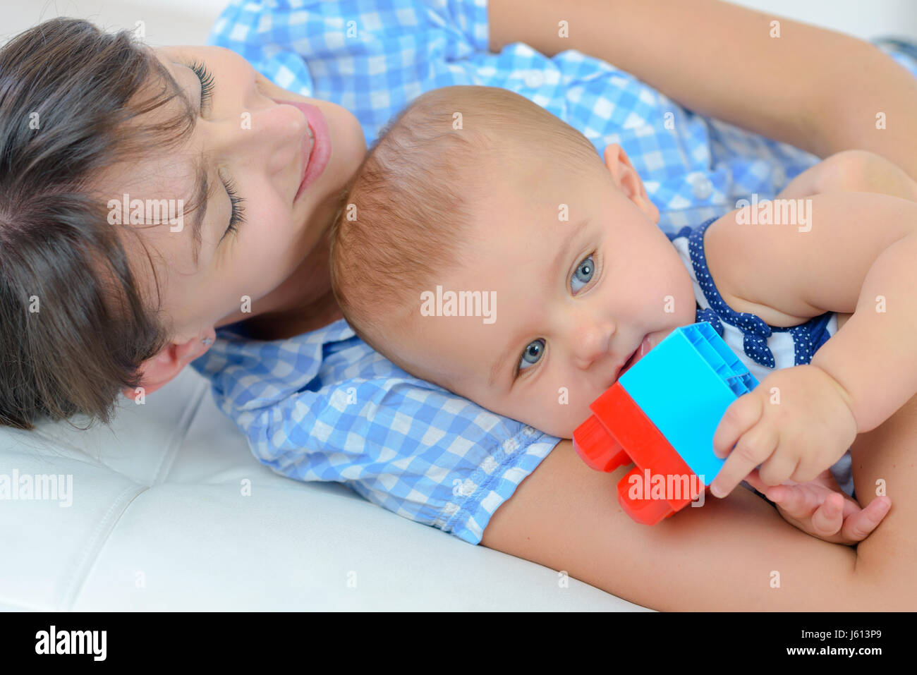 Lady cuddling baby Stock Photo - Alamy
