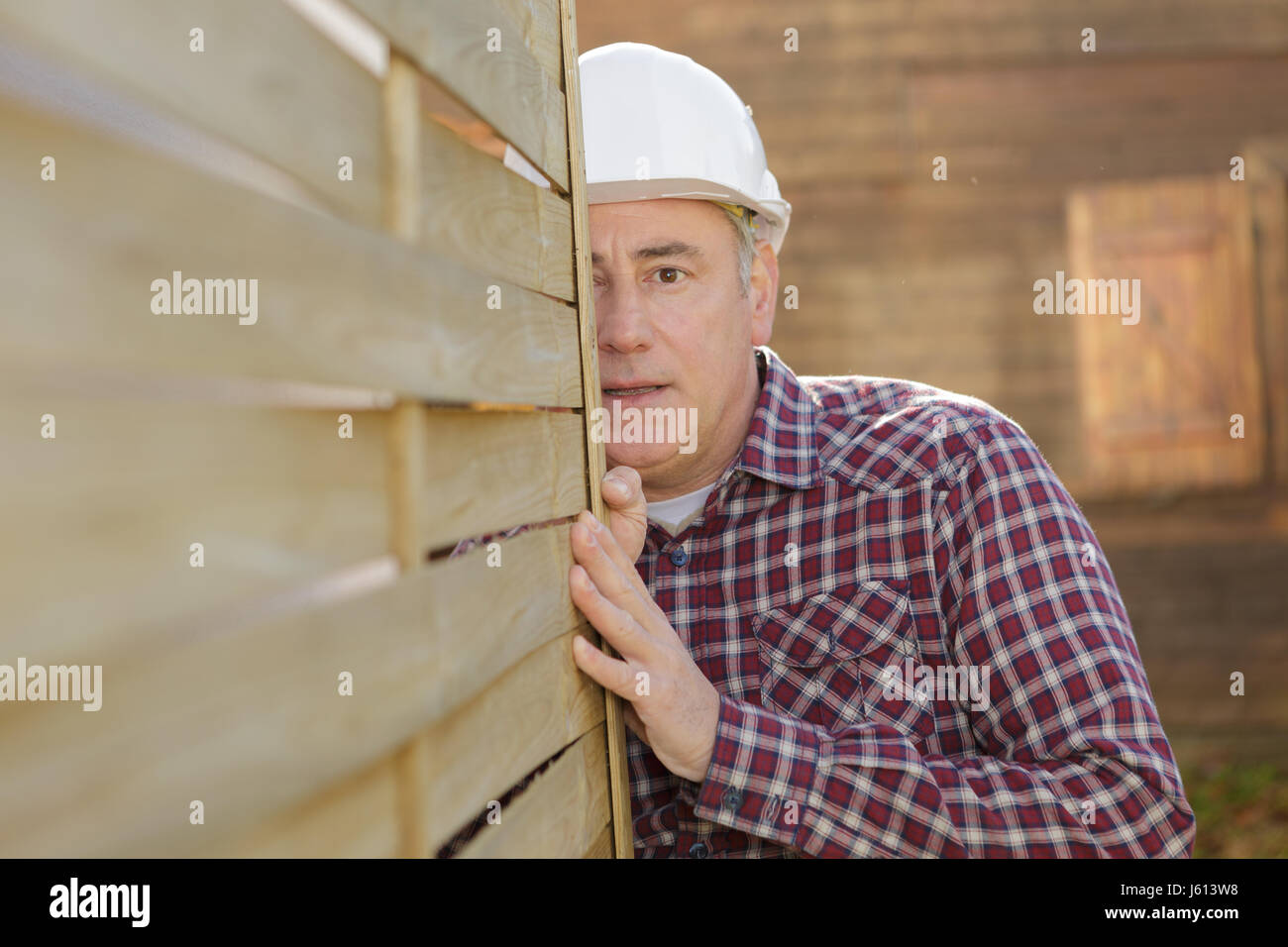 builder lining up cargo boxes outdoors a construction site Stock Photo ...