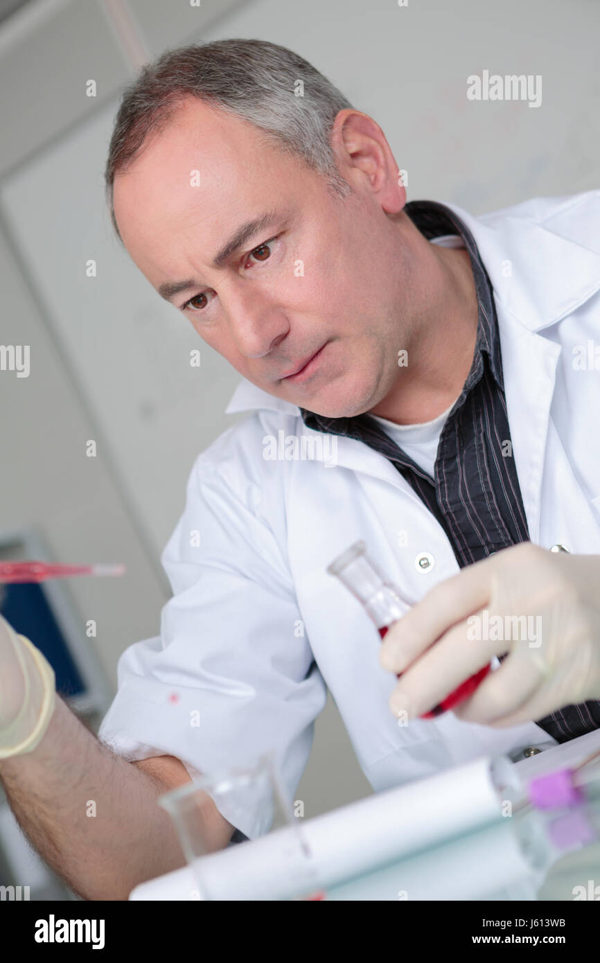 Scientist holding pipette hi-res stock photography and images - Alamy