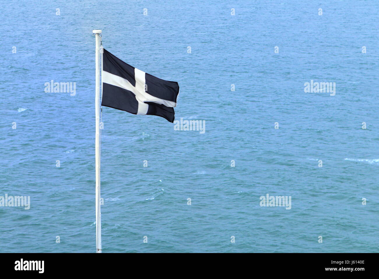 Cornish independence flag flying over the blue ocean Stock Photo - Alamy