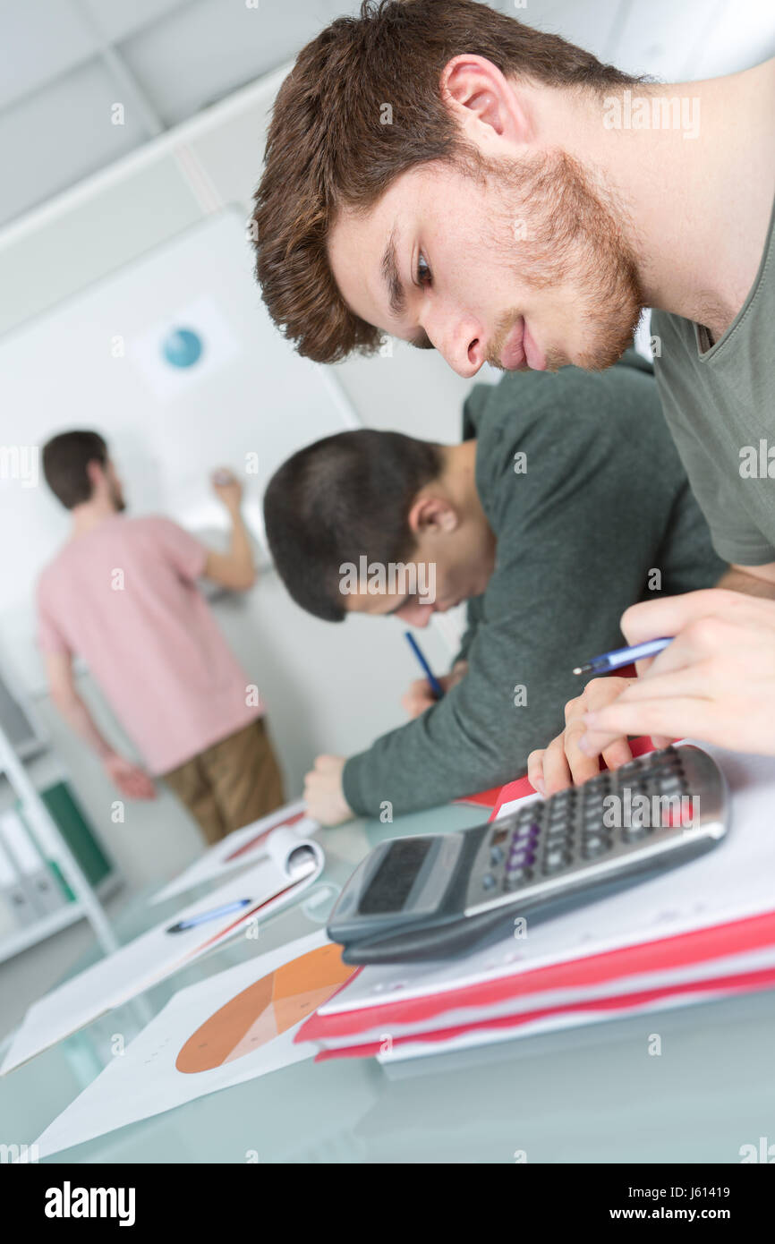 Hand using calculator class hi-res stock photography and images - Alamy