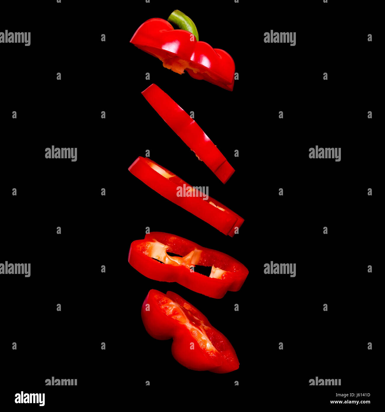 Flying red paprika. Sliced floating pepper isolated. Levity capsicum ...
