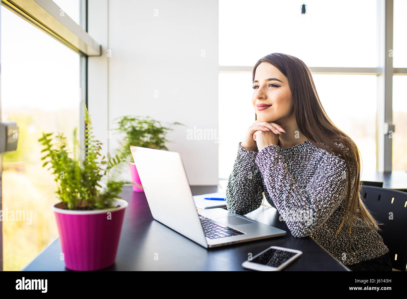 Thoughtful Pretty Office Woman Sitting at her Desk with Laptop and ...