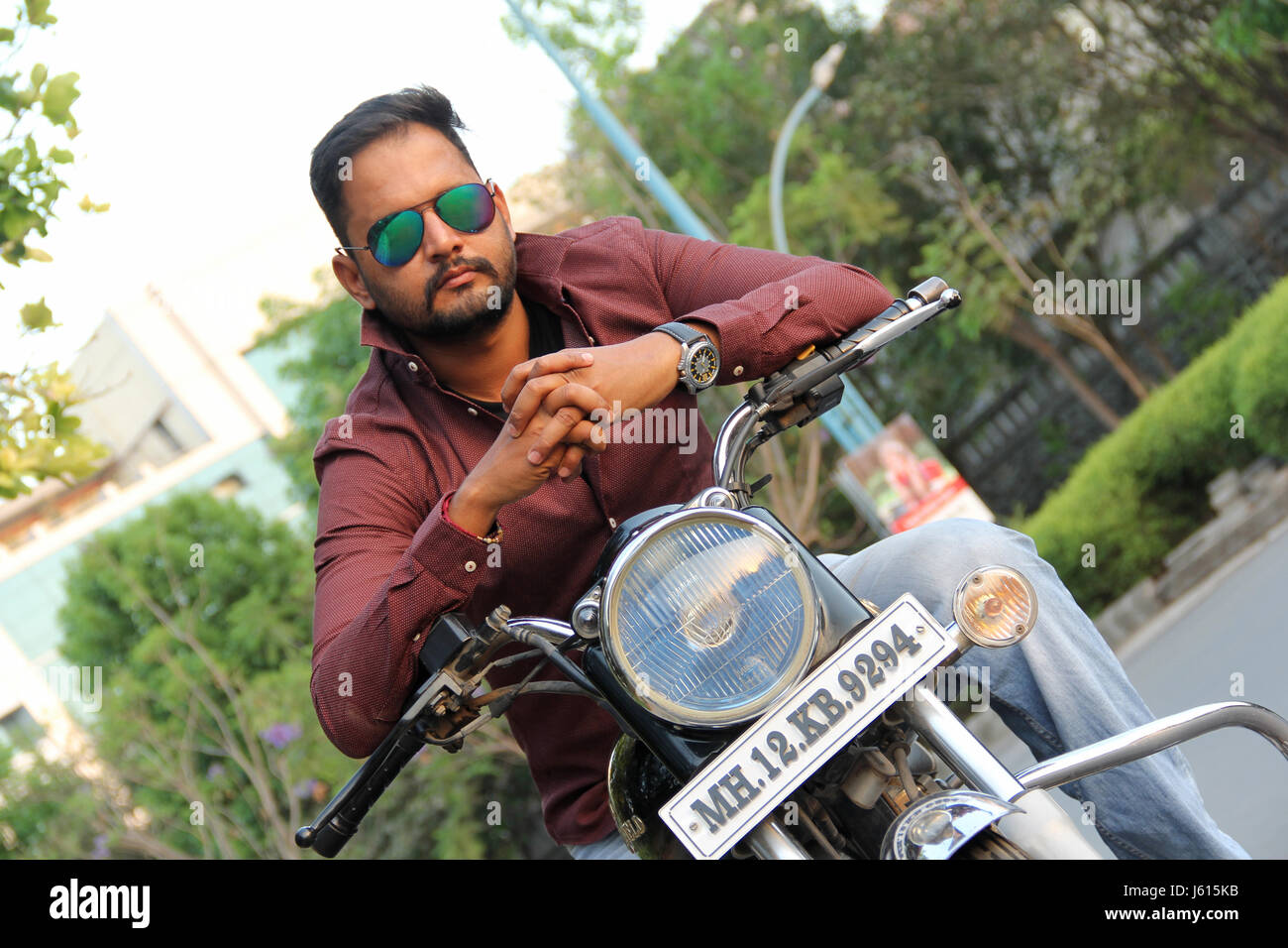 Indian man sitting on motorbike hi-res stock photography and images - Alamy