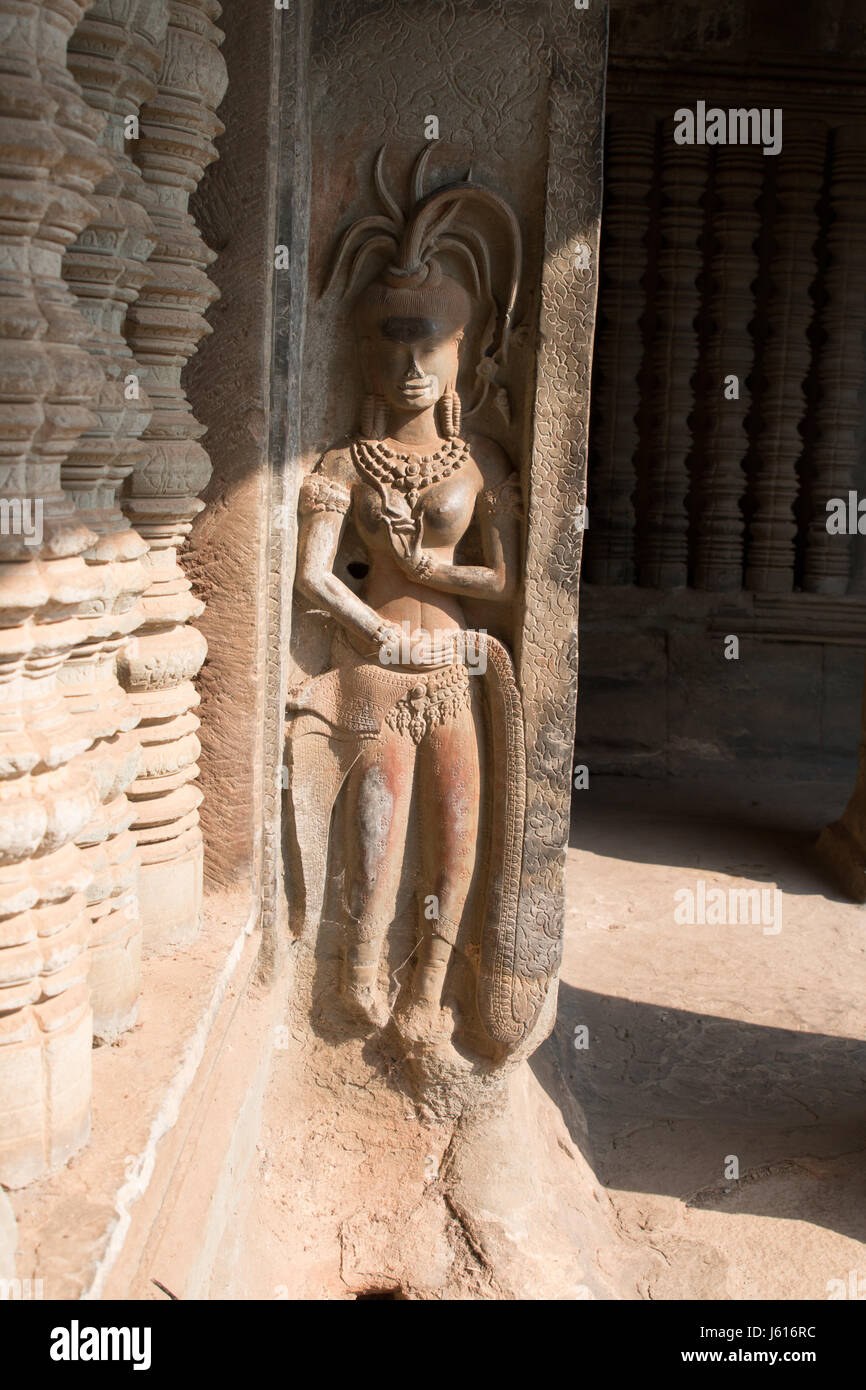 Sunlight throws the bass relief of a single apsara, heavenly nymph ...