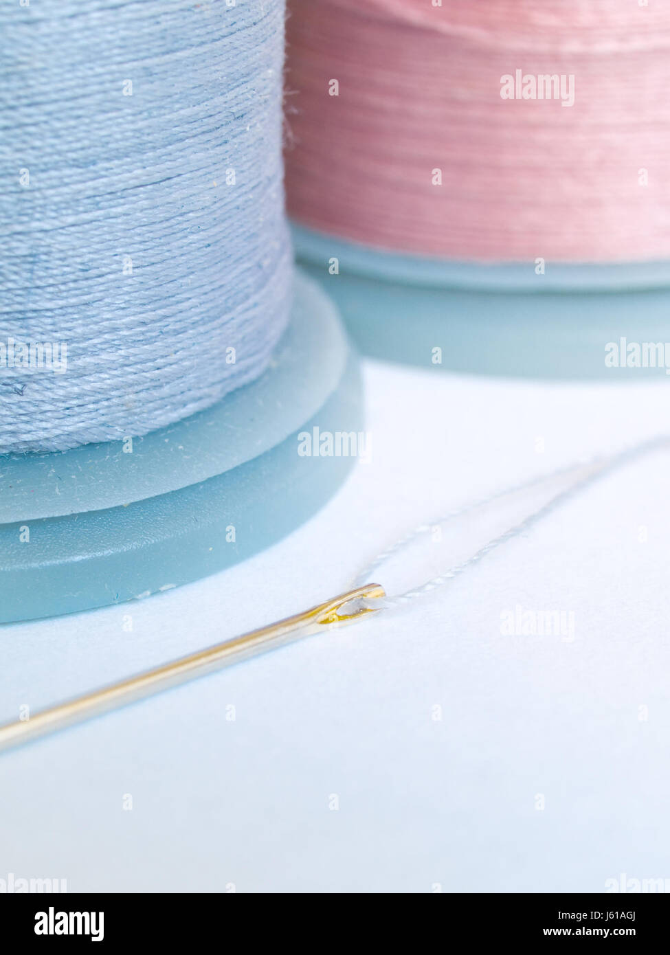 fashion hobby thread needle sewing backdrop background blue tool macro close-up Stock Photo - Alamy