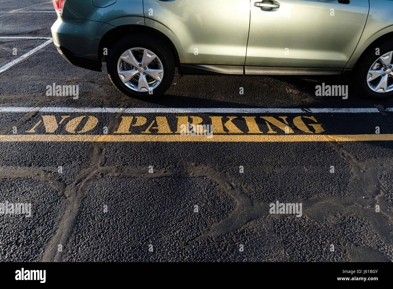 A No Parking sign painted on a parking lot in Oklahoma, USA. A vehicle ...