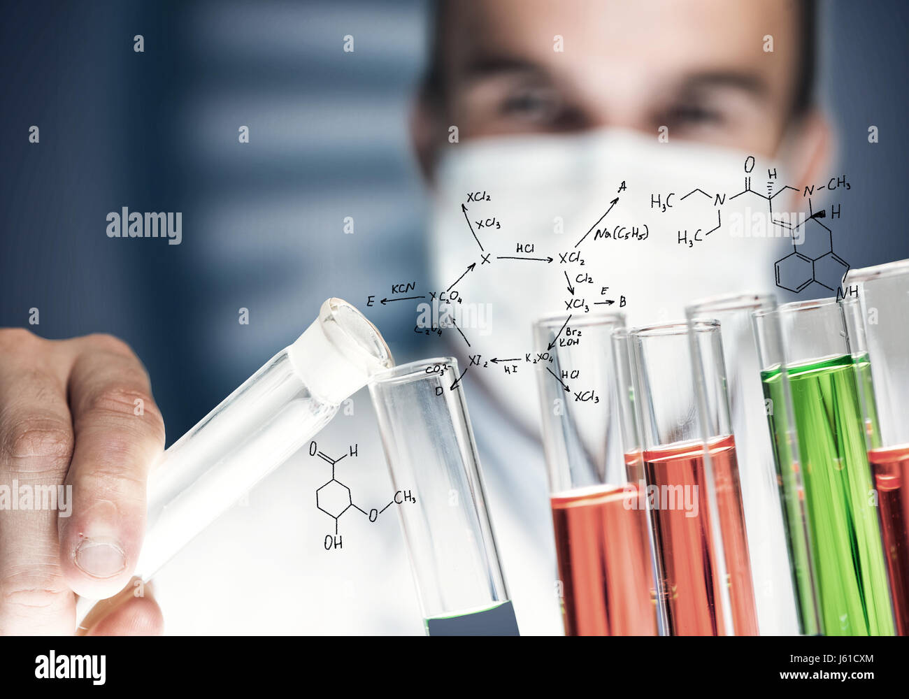 Young scientist mixing reagents in glass flask in clinical laboratory ...