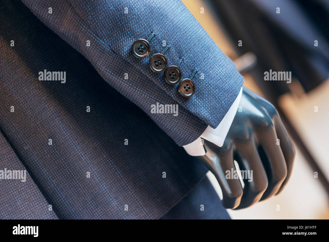 Closeup of suit sleeve and button in dark blue color Stock Photo - Alamy